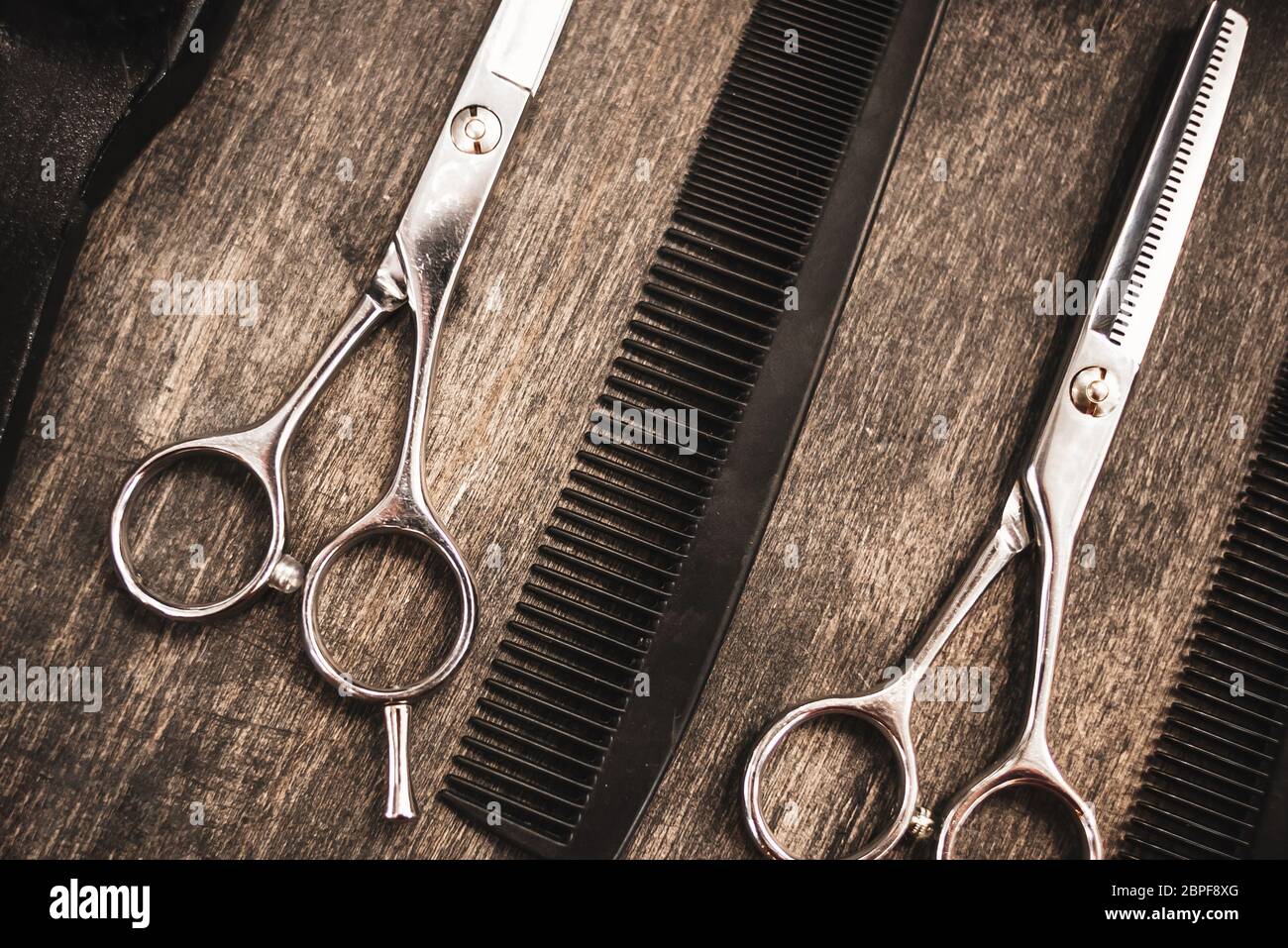 metal scissors and black combs for haircuts are in the hairdresser ...