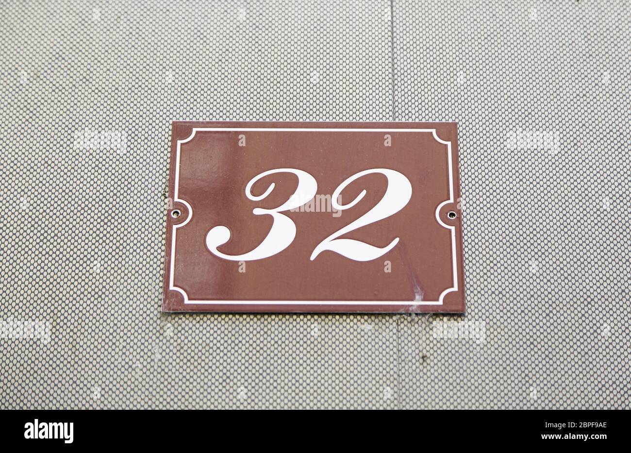 Number thirty-two on the wall of a house, number of information, even ...
