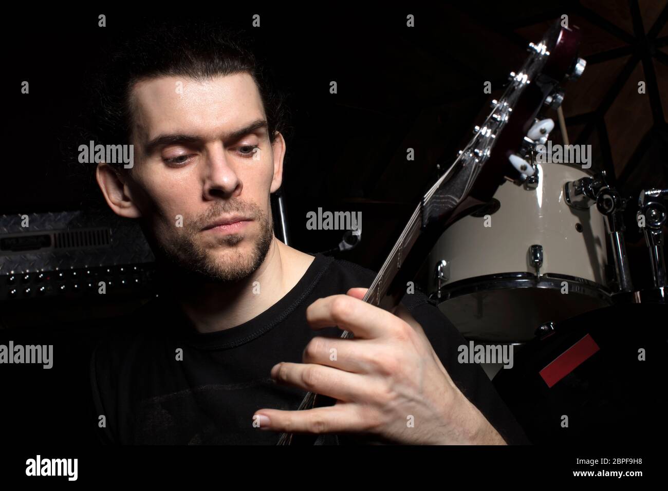 A man plays the guitar. Face of a man with a musical instrument on a ...