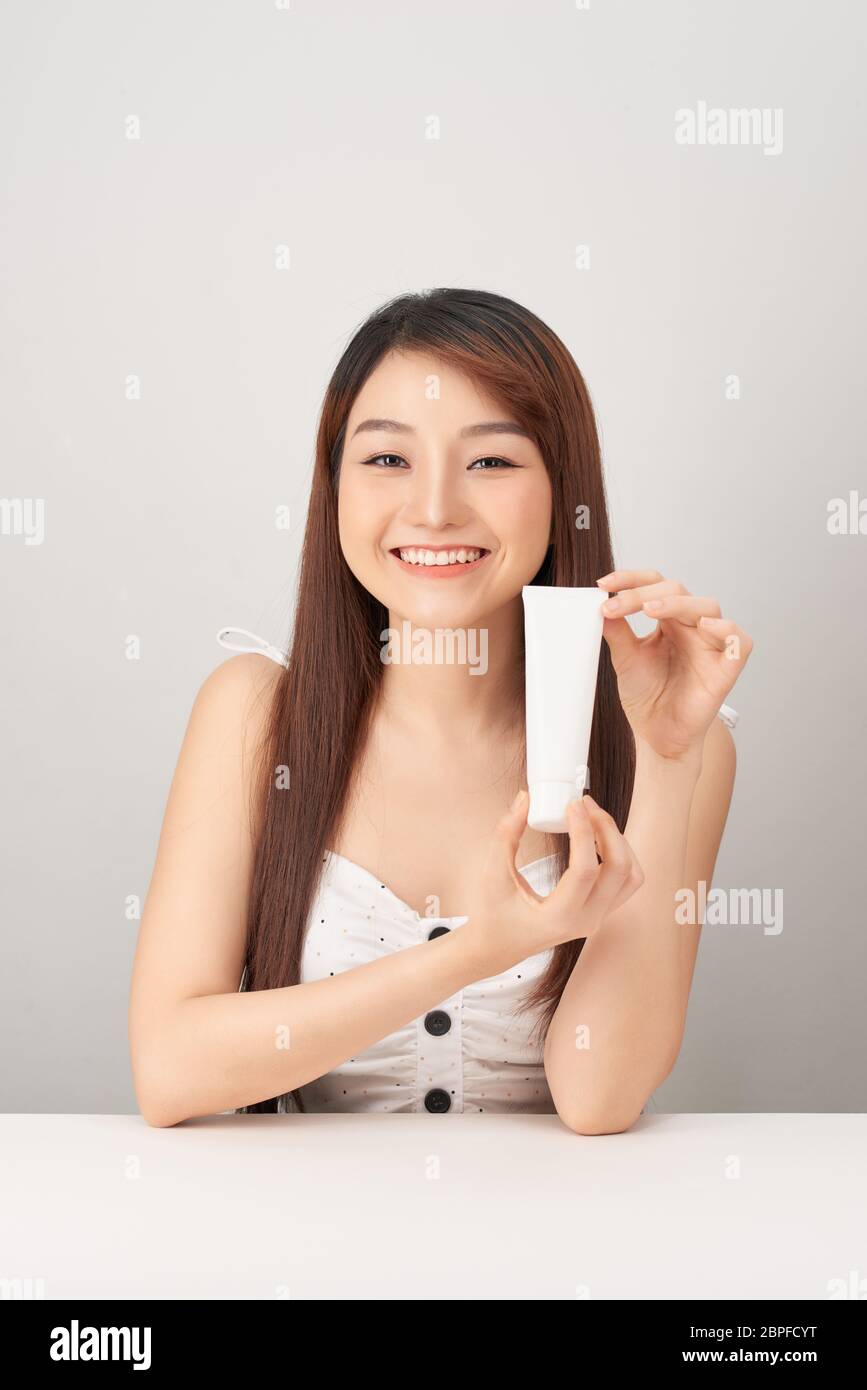 Asian woman model present showing cosmetic make up package products ...