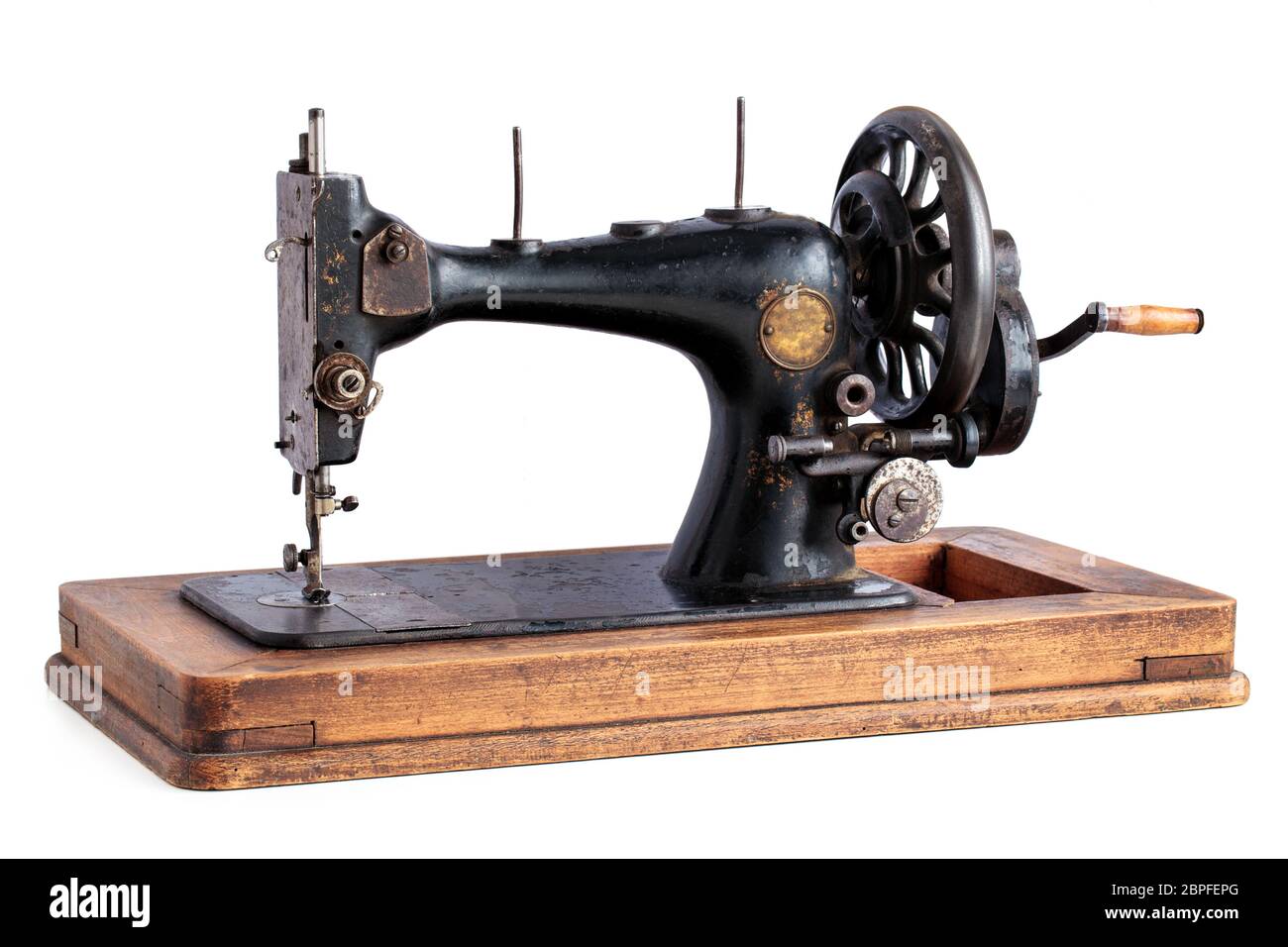 Ancient sewing machine isolated on white background Stock Photo - Alamy