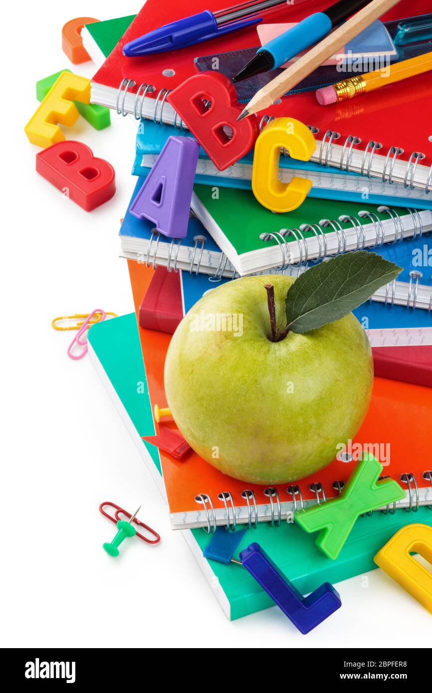 School supplies and green apple isolated on white background Stock ...