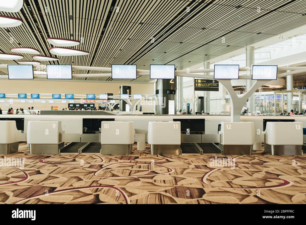 Check-in desks at Airport terminal Stock Photo - Alamy