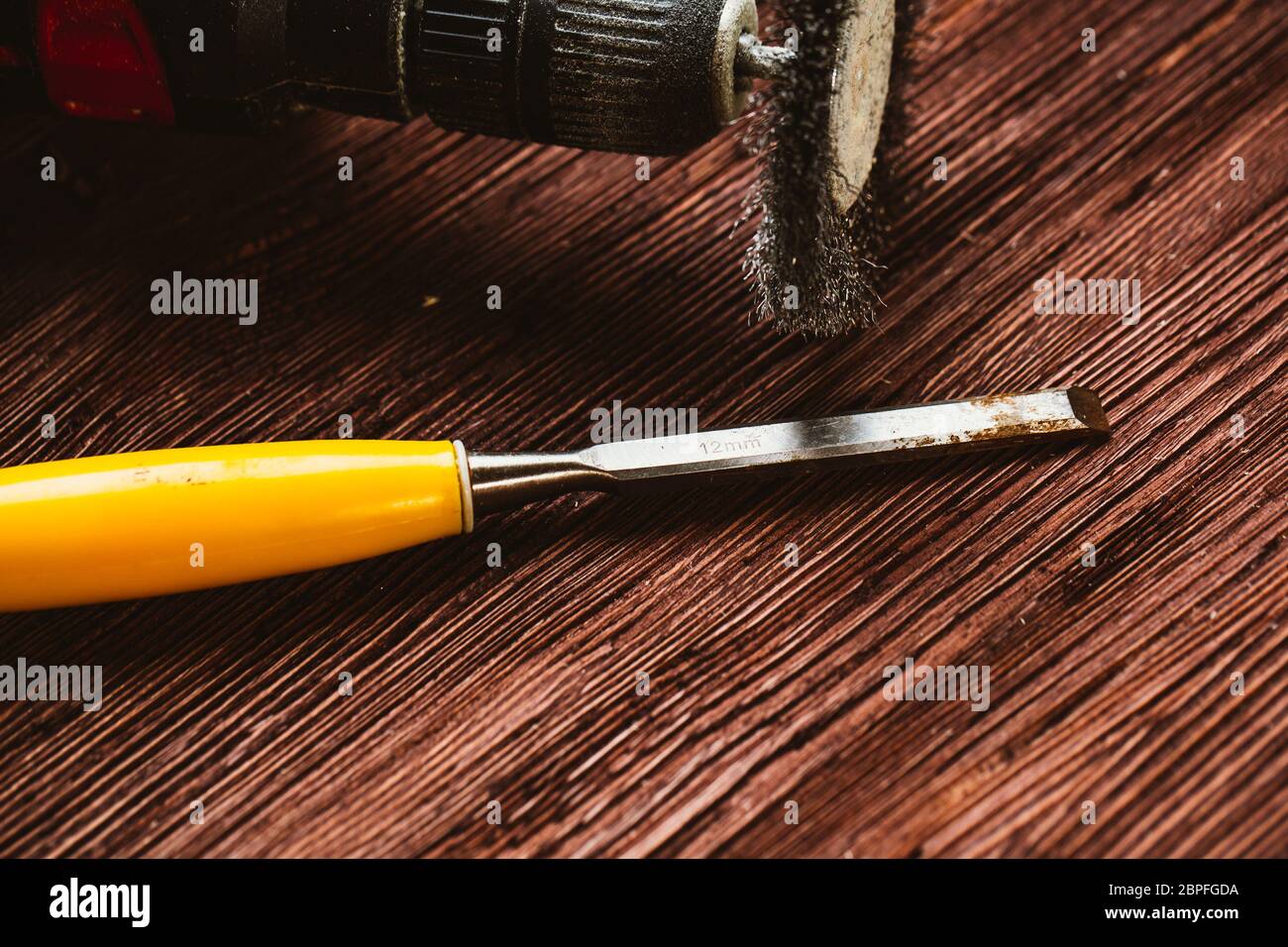 Brush drill and chisel on the dark wooden background Stock Photo - Alamy