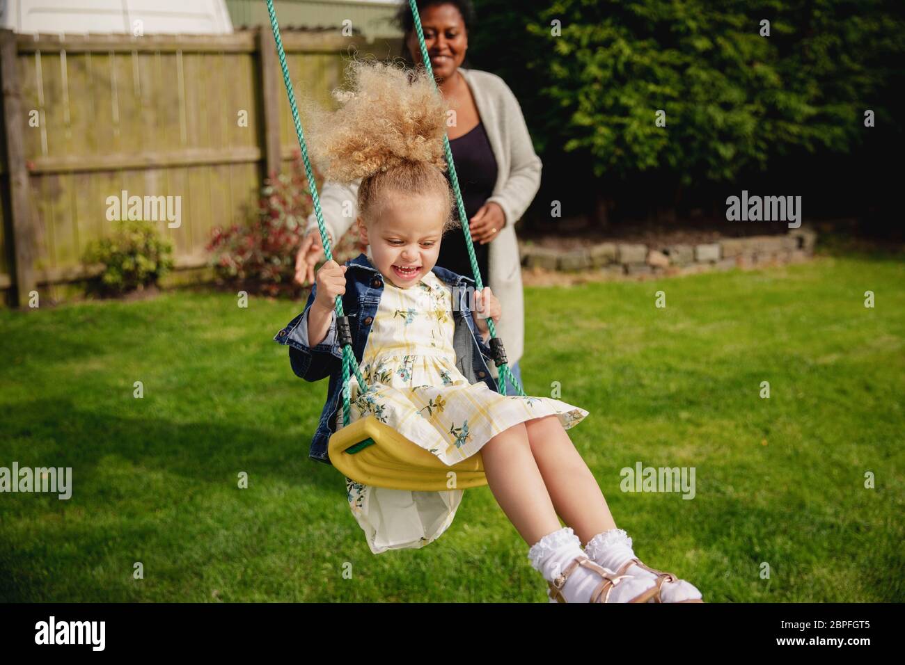Child pushed on swing hi-res stock photography and images - Alamy