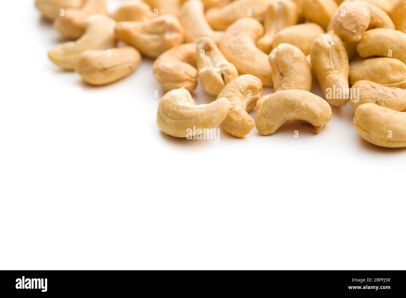 Roasted cashew nuts isolated on white background Stock Photo - Alamy