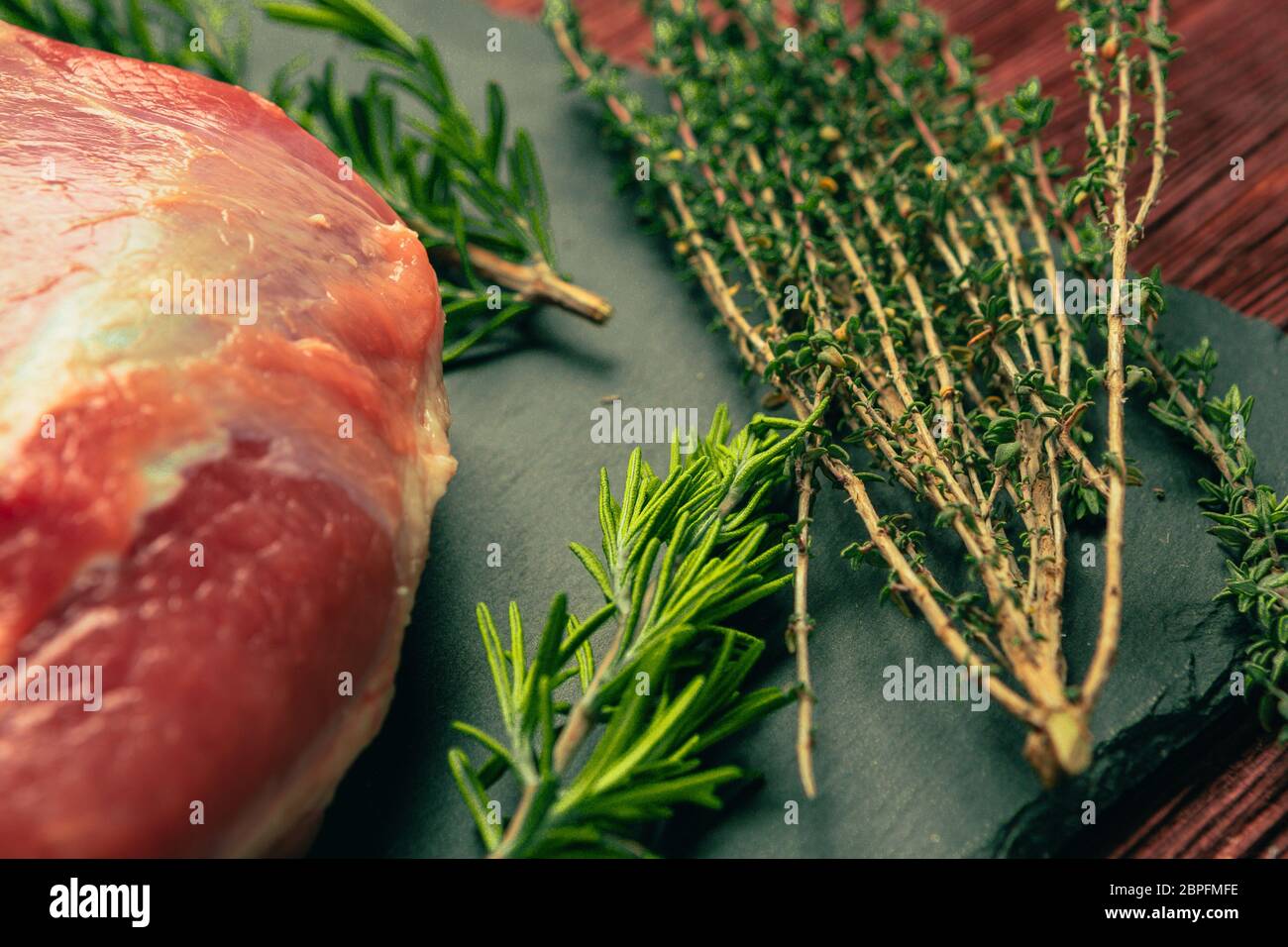 raw pork meat with spices on slate stone kitchen board Stock Photo - Alamy