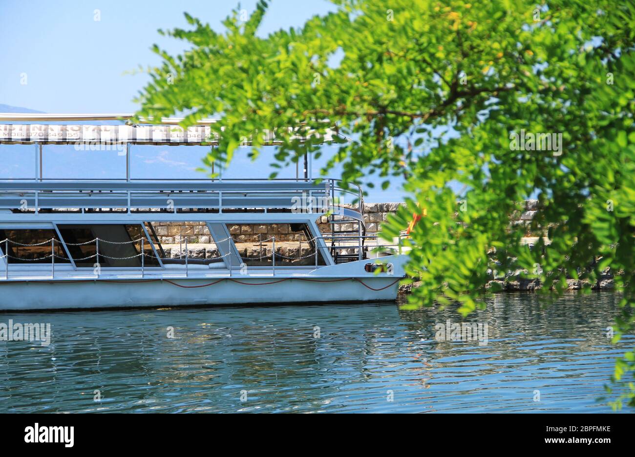 small tourist boat in lake Stock Photo - Alamy