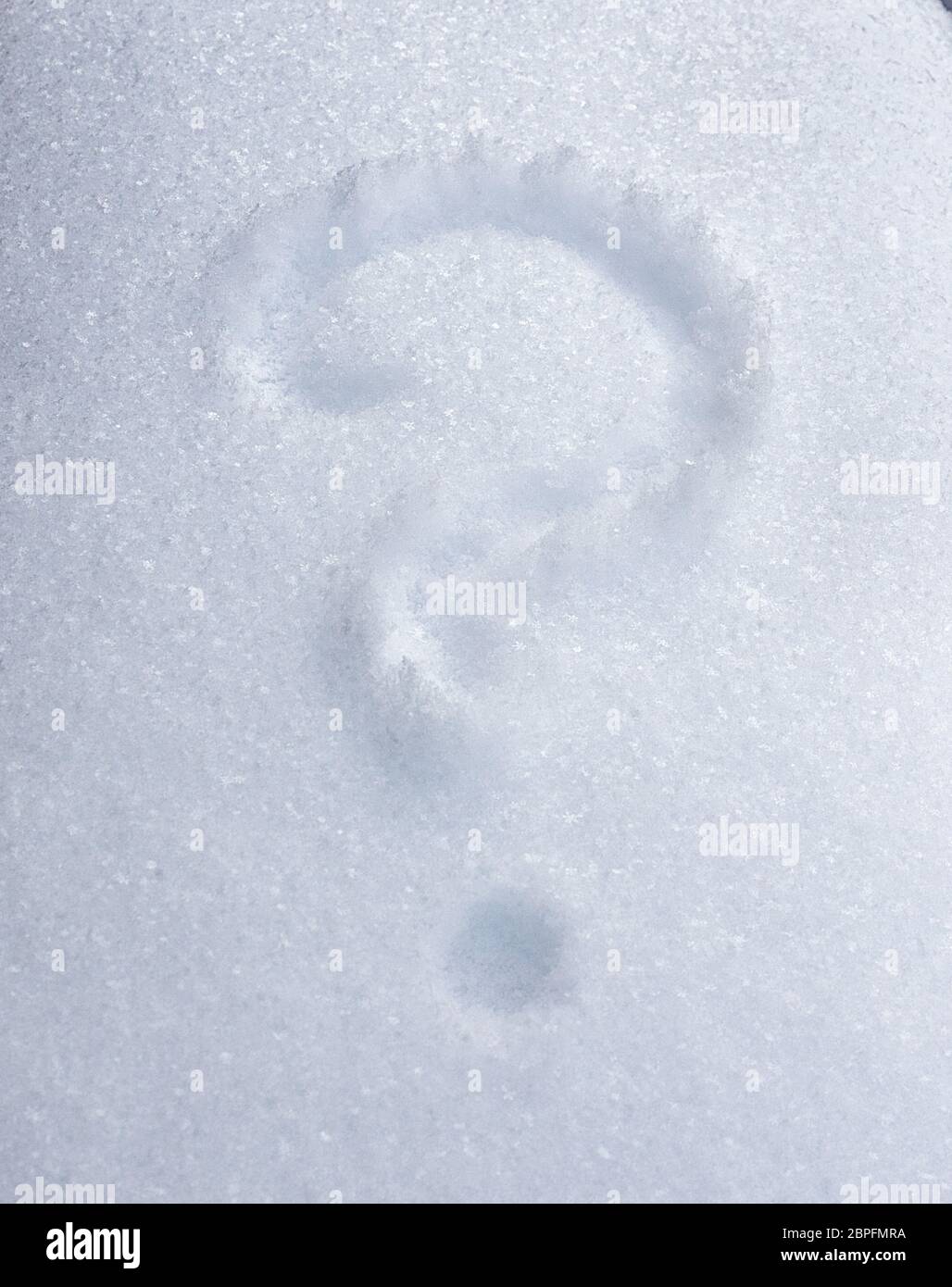 question mark drawn on white snow on a winter day, top view Stock Photo ...