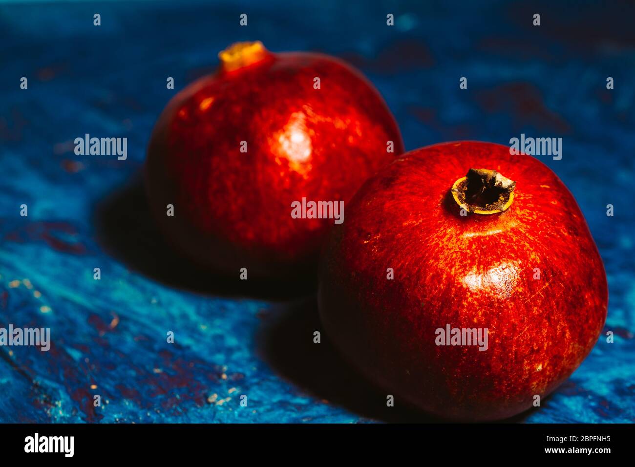 Whole red garnet on blue abstract backround Stock Photo - Alamy