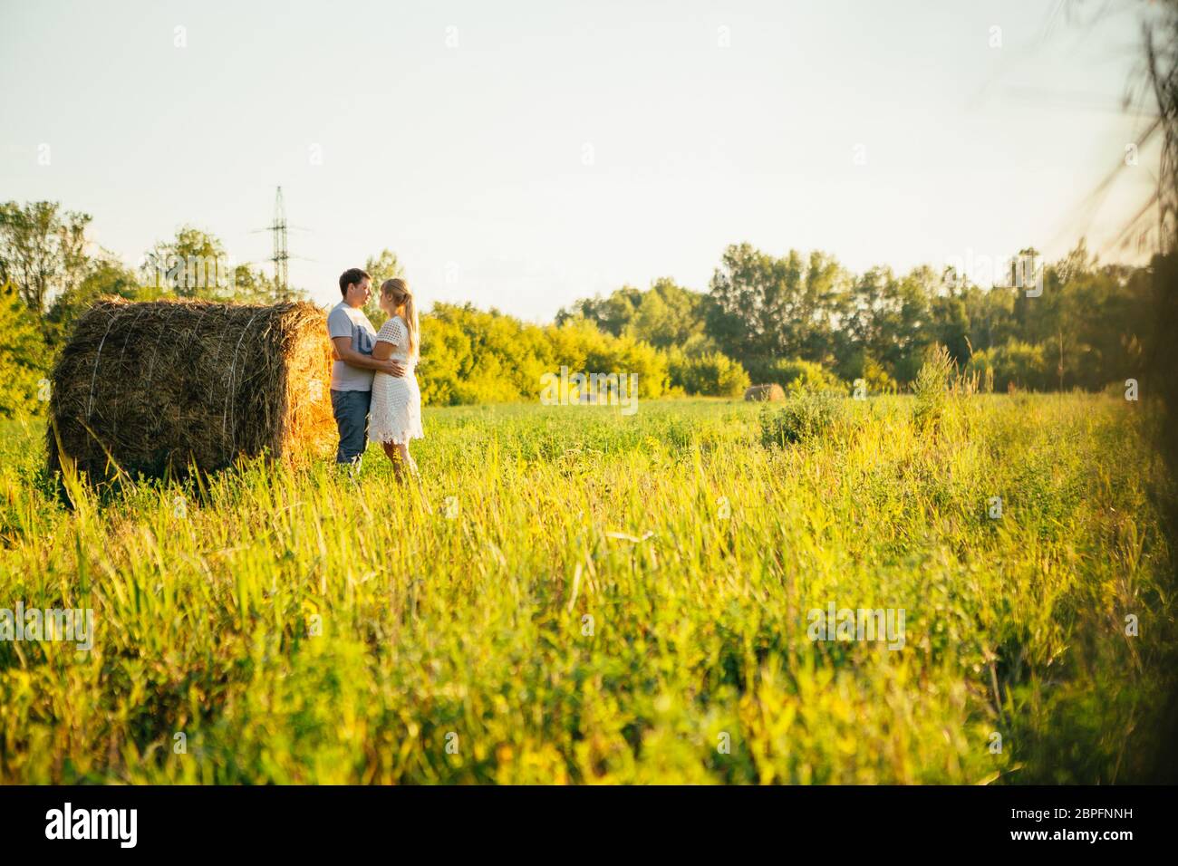 love story man and woman on the background of haystacks and sun Stock ...
