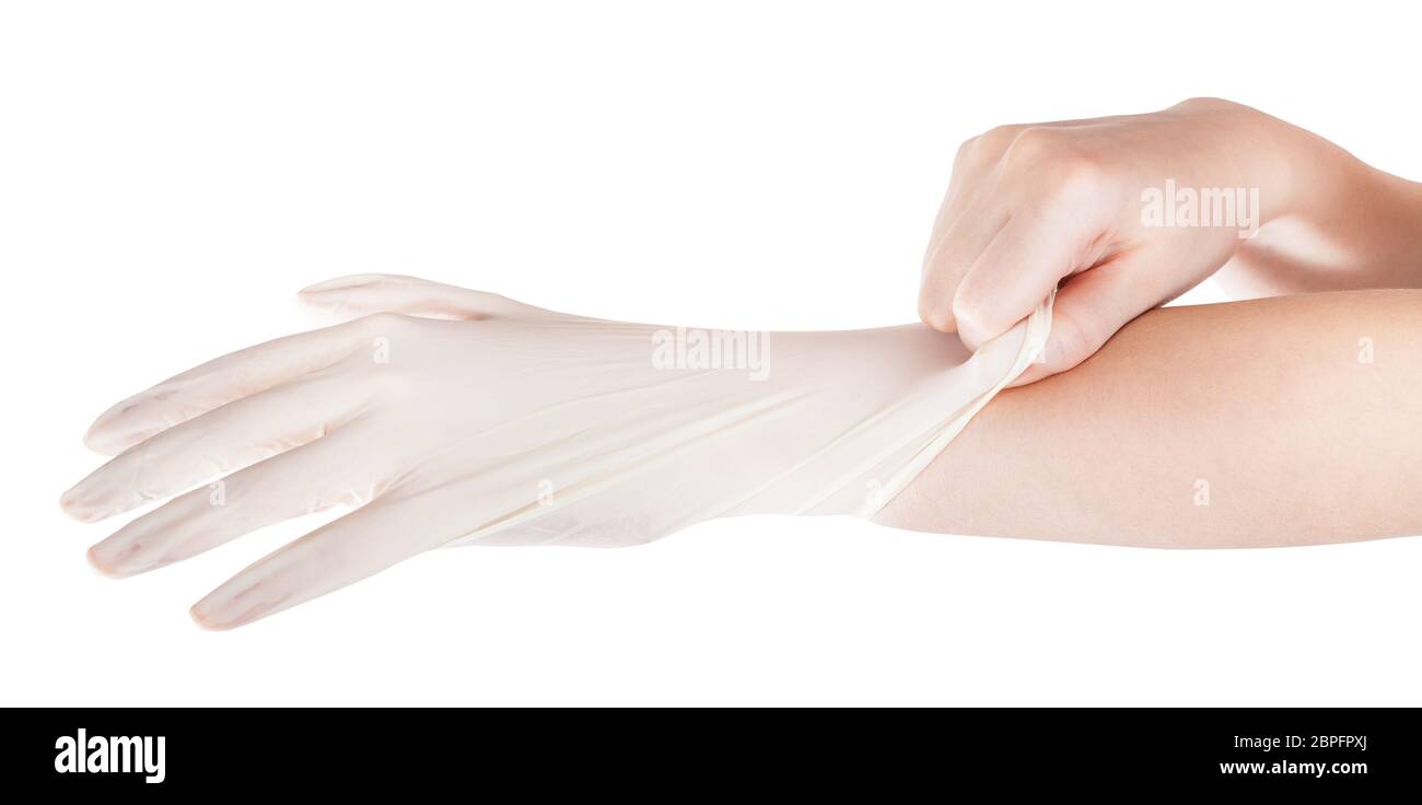 side view of female hand pulls latex glove on another hand isolated on ...