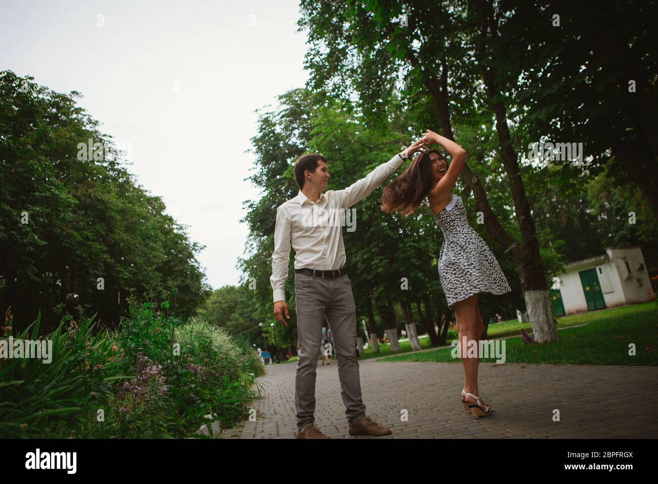 Beautiful young couple on a nature background Stock Photo - Alamy