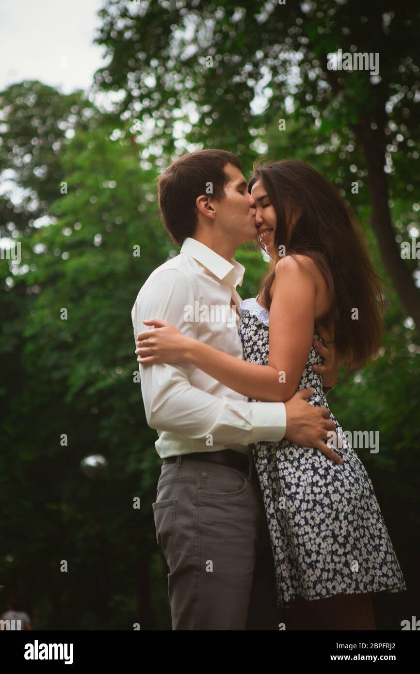 Beautiful young couple on a nature background Stock Photo - Alamy