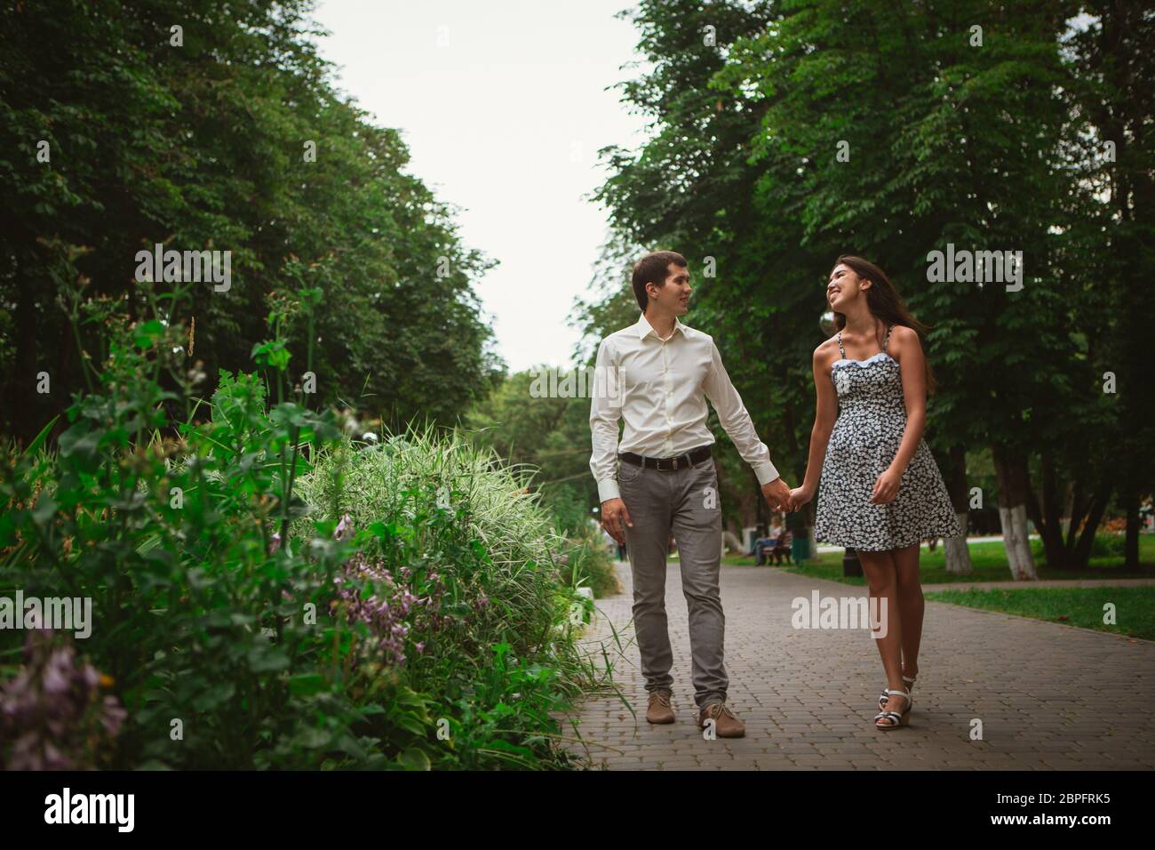 Beautiful young couple on a nature background Stock Photo - Alamy