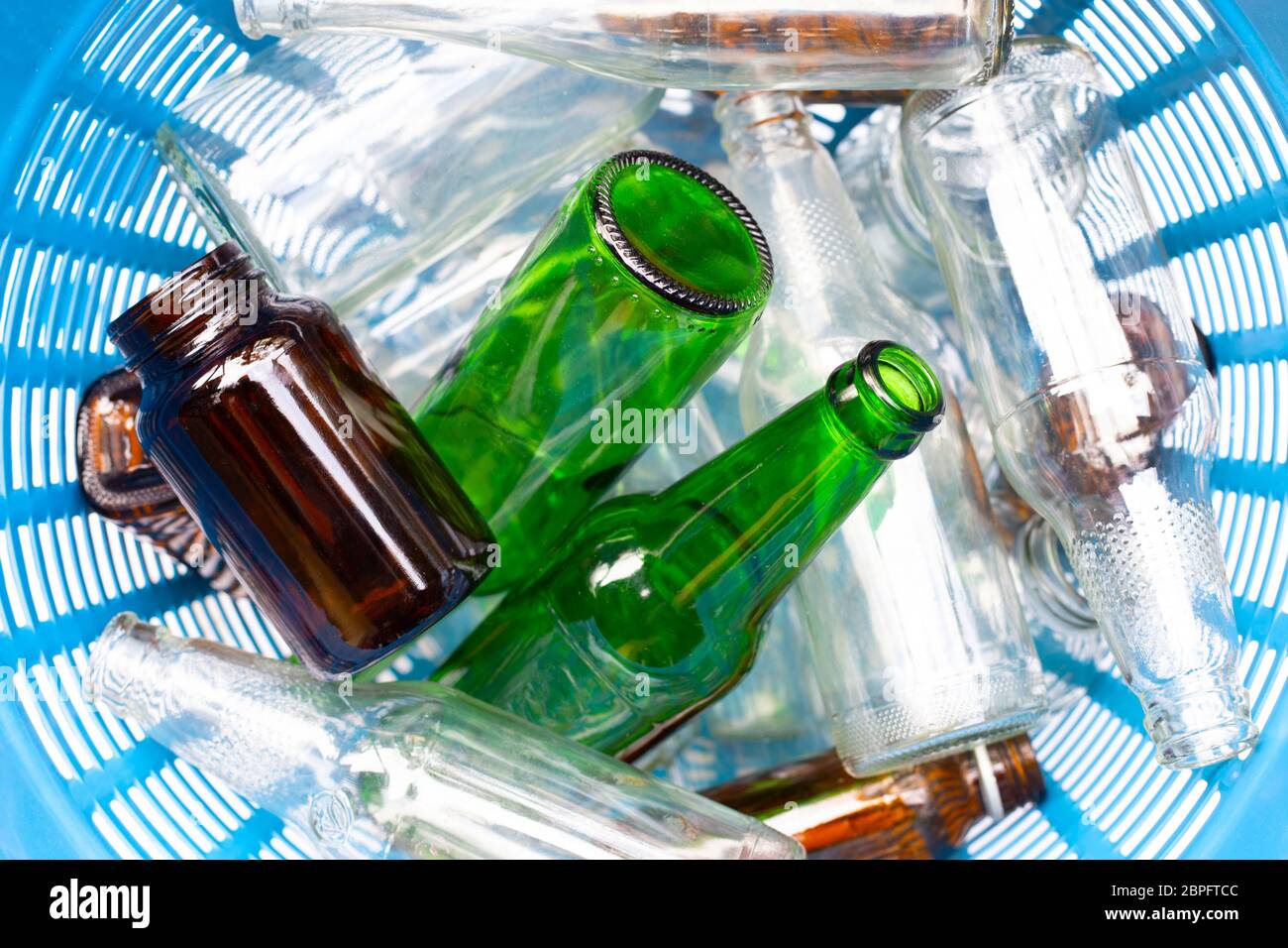 Glass bottles in blue waste basket Stock Photo - Alamy
