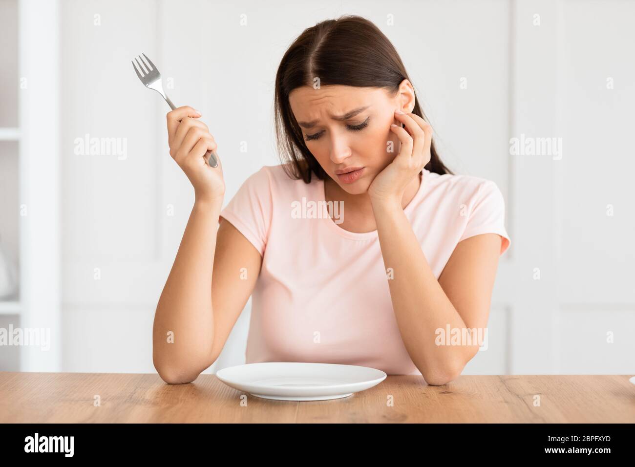 Hungry woman empty plate hi-res stock photography and images - Alamy