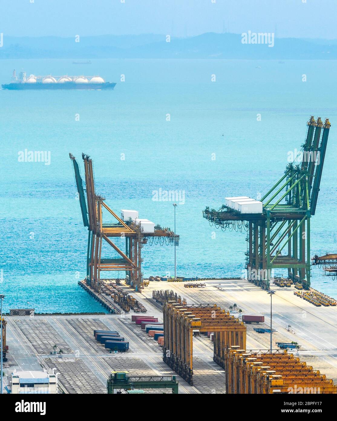 Aerial view of Singapore commercial port harbor with cranes and ...