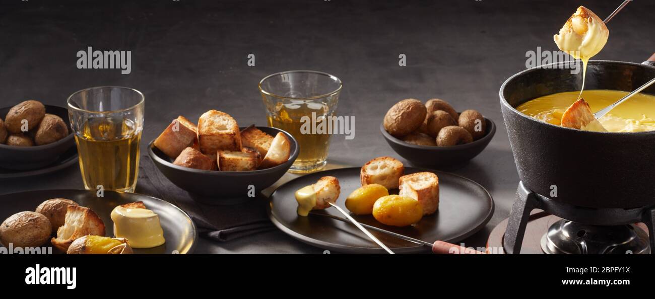 Panorama banner with cheese fondue with dipping accompaniments and ...