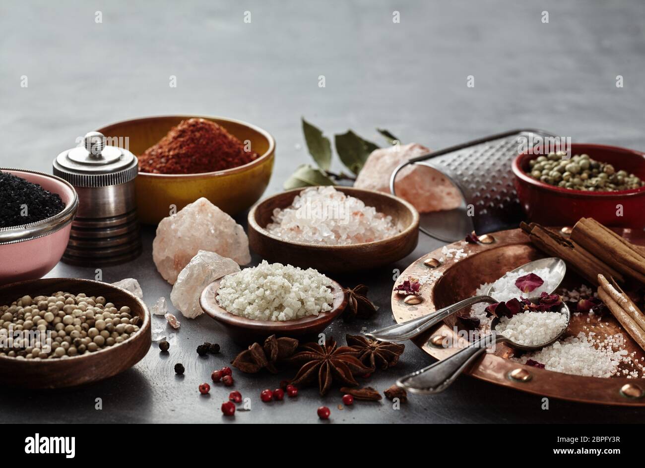 Cooking still life with assorted natural rock and sea salts, bay leaves ...