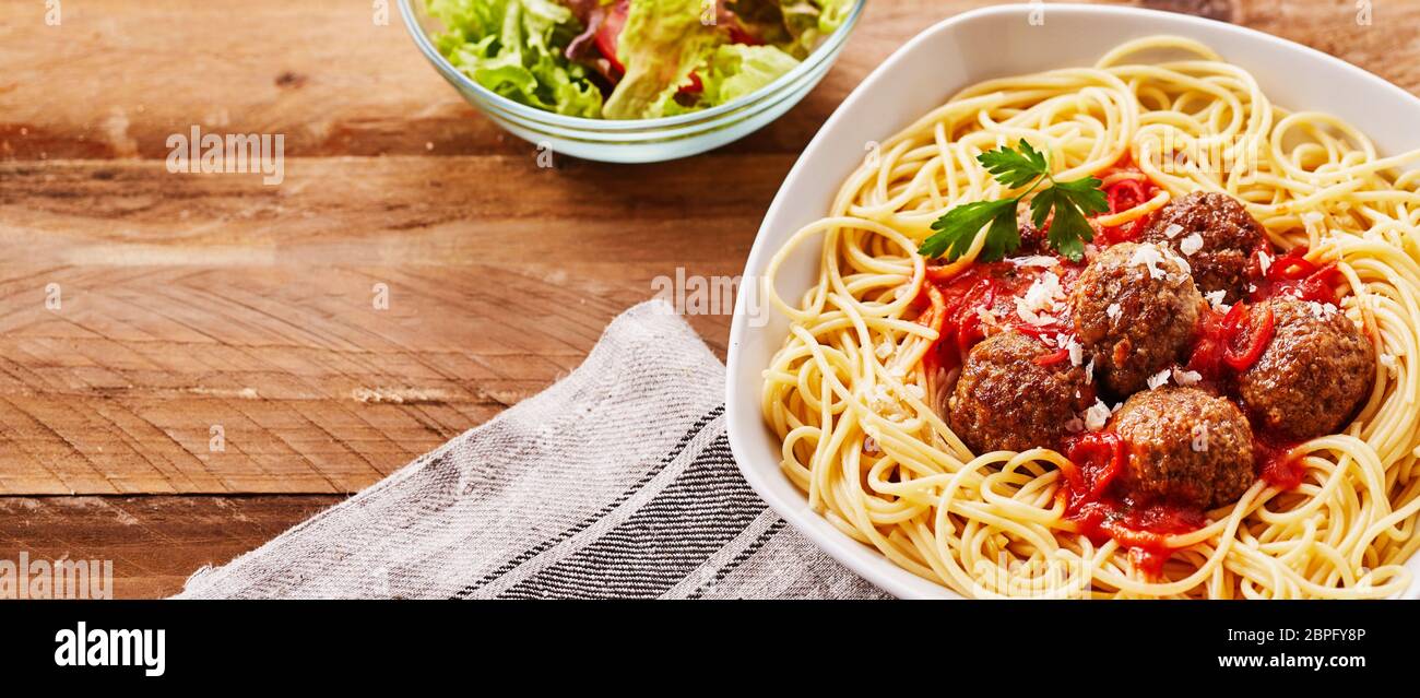 Serving of spicy mini meatballs with spaghetti pasta or noodles on ...