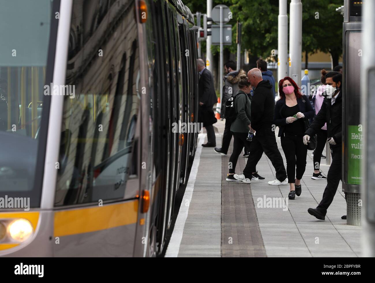 People wearing face covering on the Luas platform outside Heuston ...