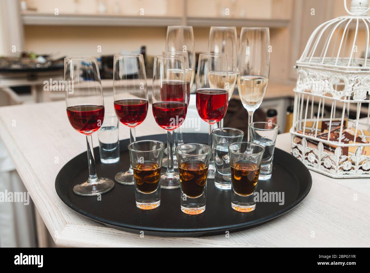 different alcohol drinks on a tray. wine, champagne, cognac, vodka ...