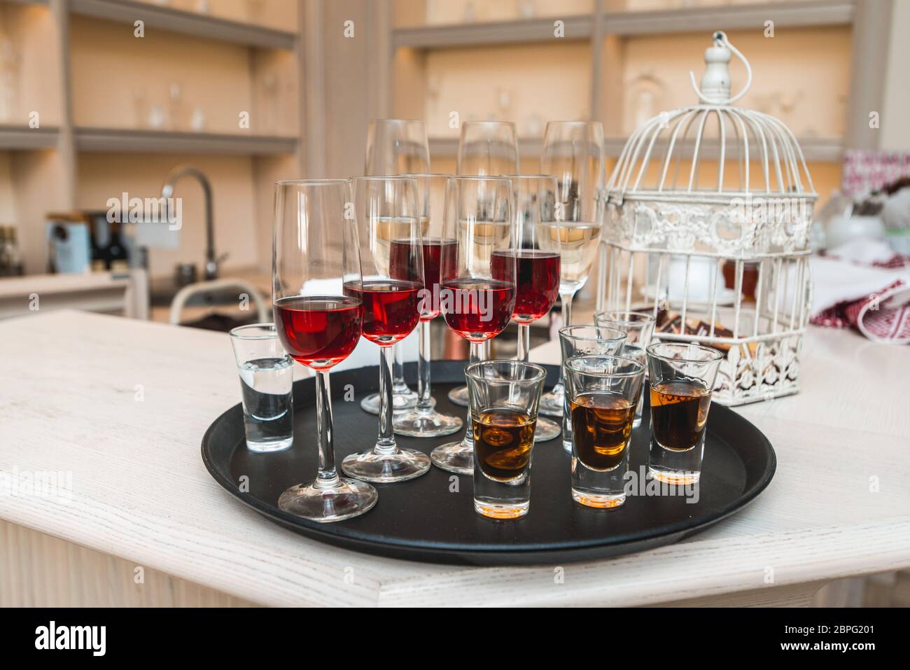 different alcohol drinks on a tray. wine, champagne, cognac, vodka ...