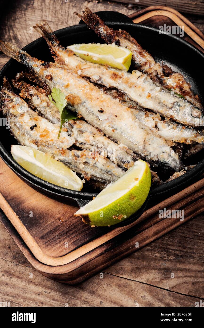 Fish fried breaded on iron cast pan.Deep-fried fish Stock Photo - Alamy