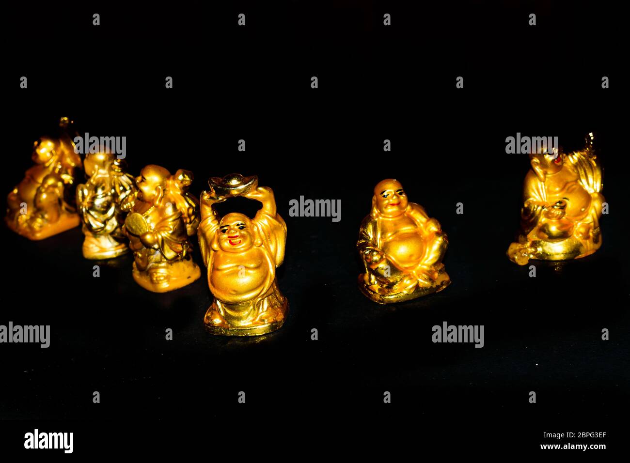 A Golden Laughing Buddhas with relaxed mindset. Isolated in a dark ...