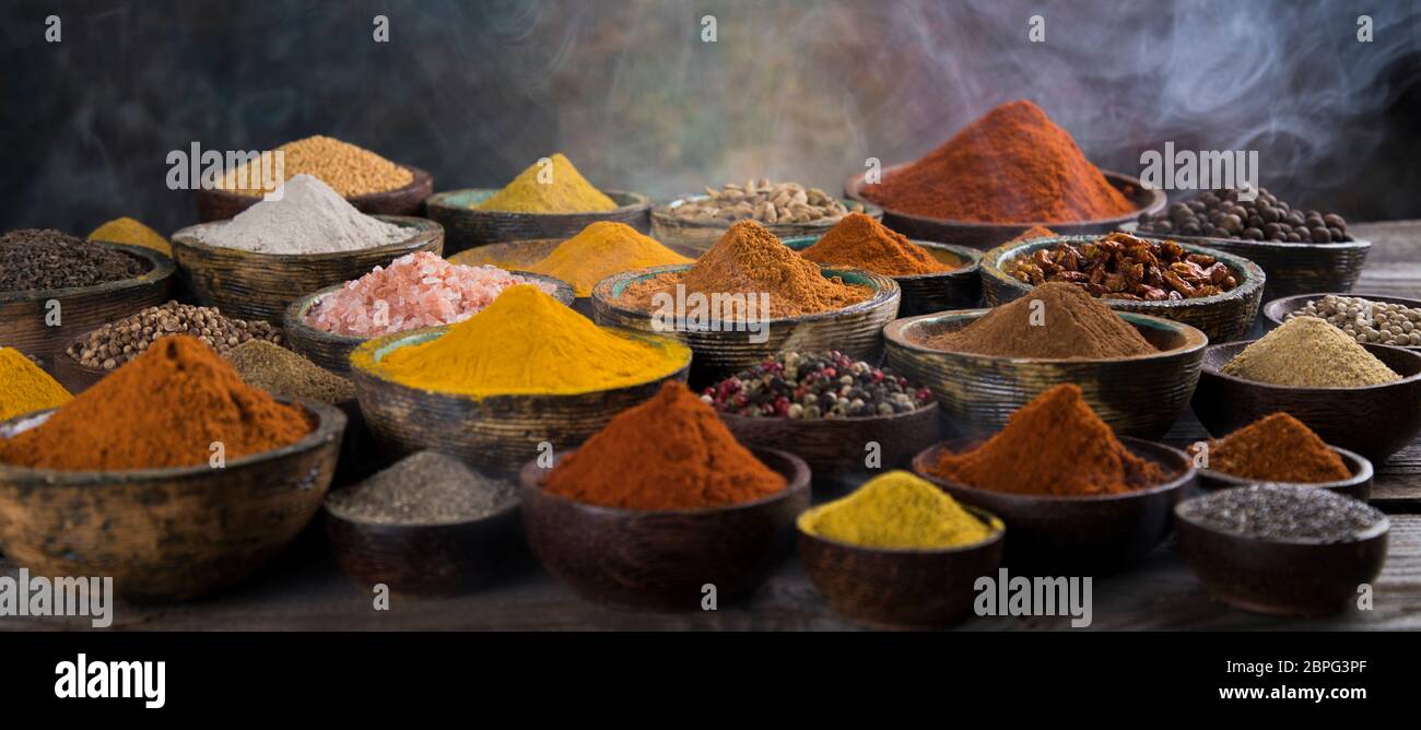 Smoke, Aromatic spices on wooden background Stock Photo - Alamy