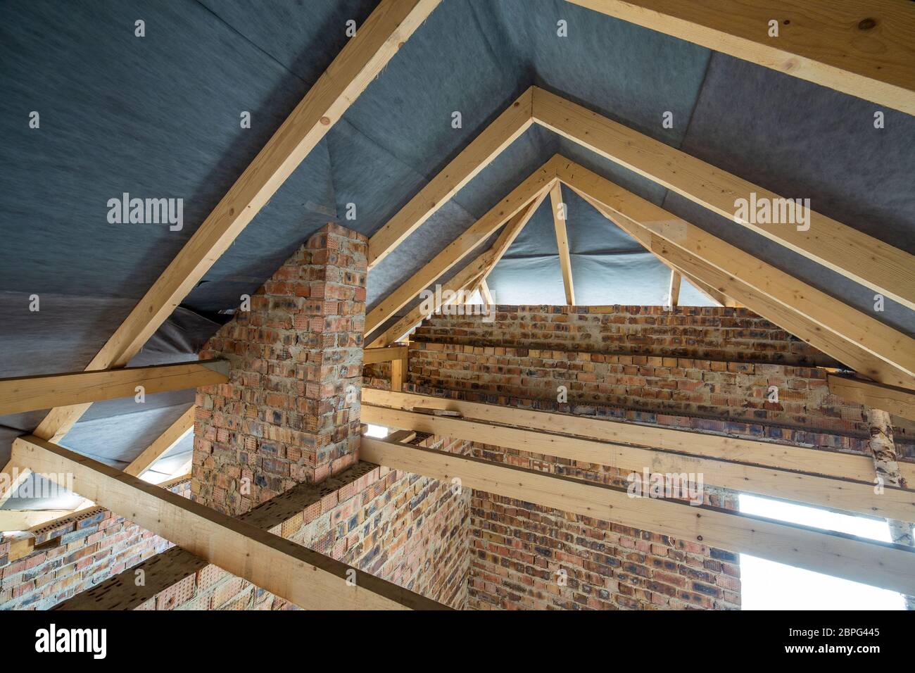 Attic space of a building under construction with wooden beams of a ...
