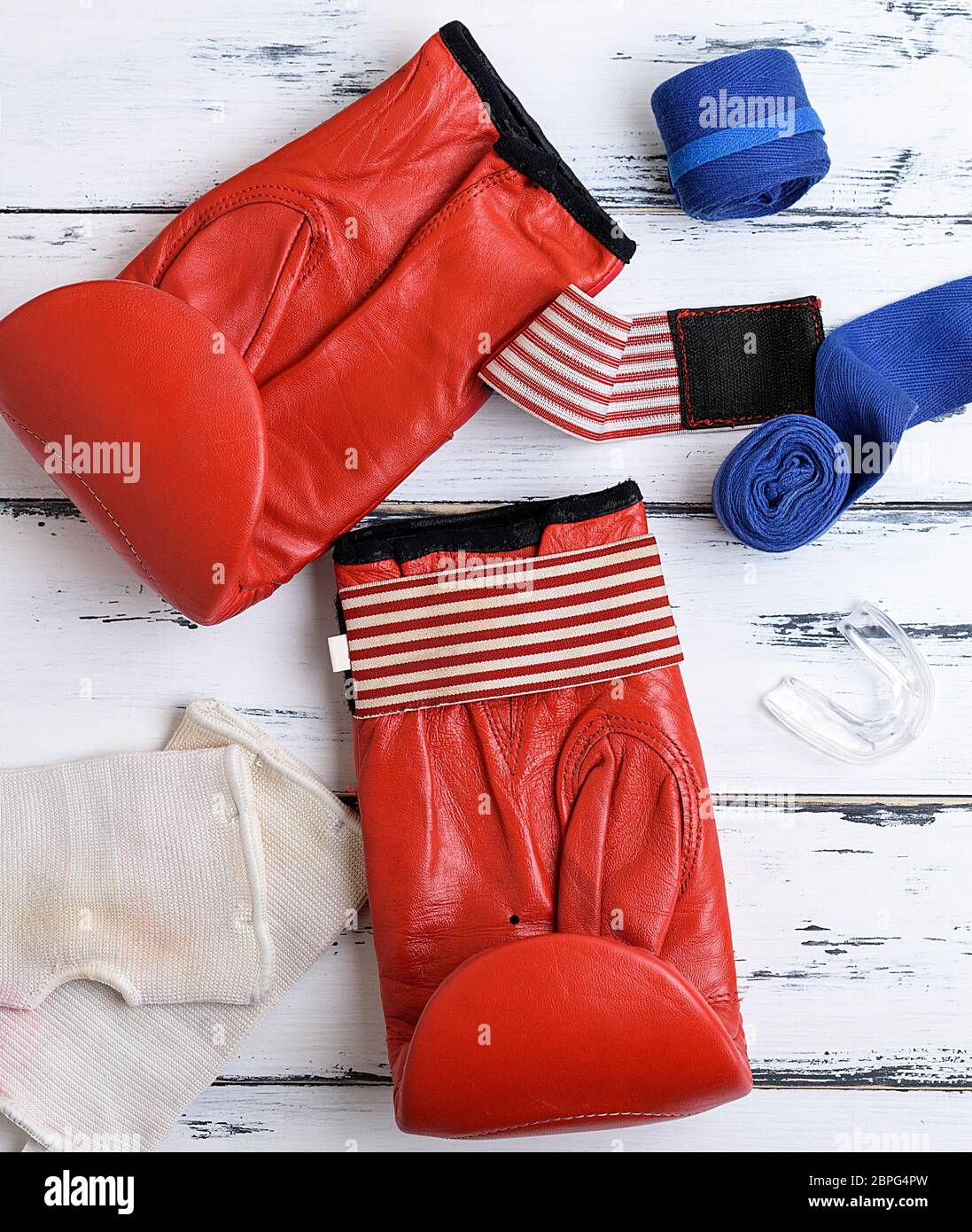 pair of red leather boxing gloves, blue textile bandage, silicone ...
