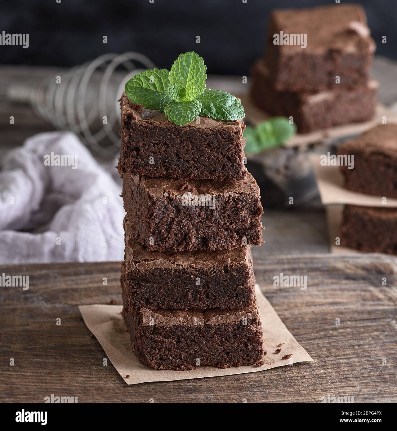 stack of square pieces of baked brown brownie pie on a wooden board Stock Photo - Alamy
