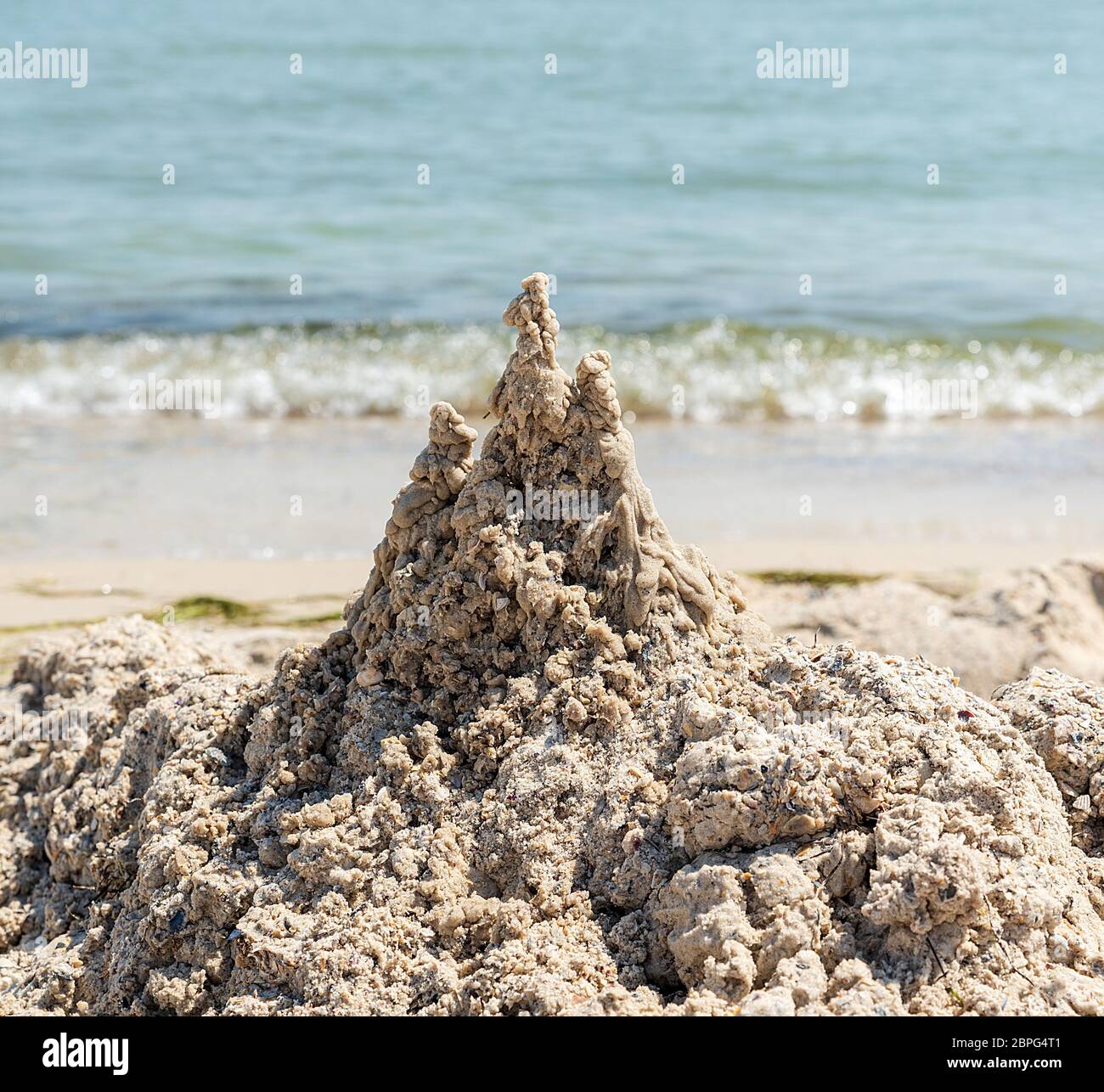 large pile of wet sand on the beach on a summer day Stock Photo - Alamy