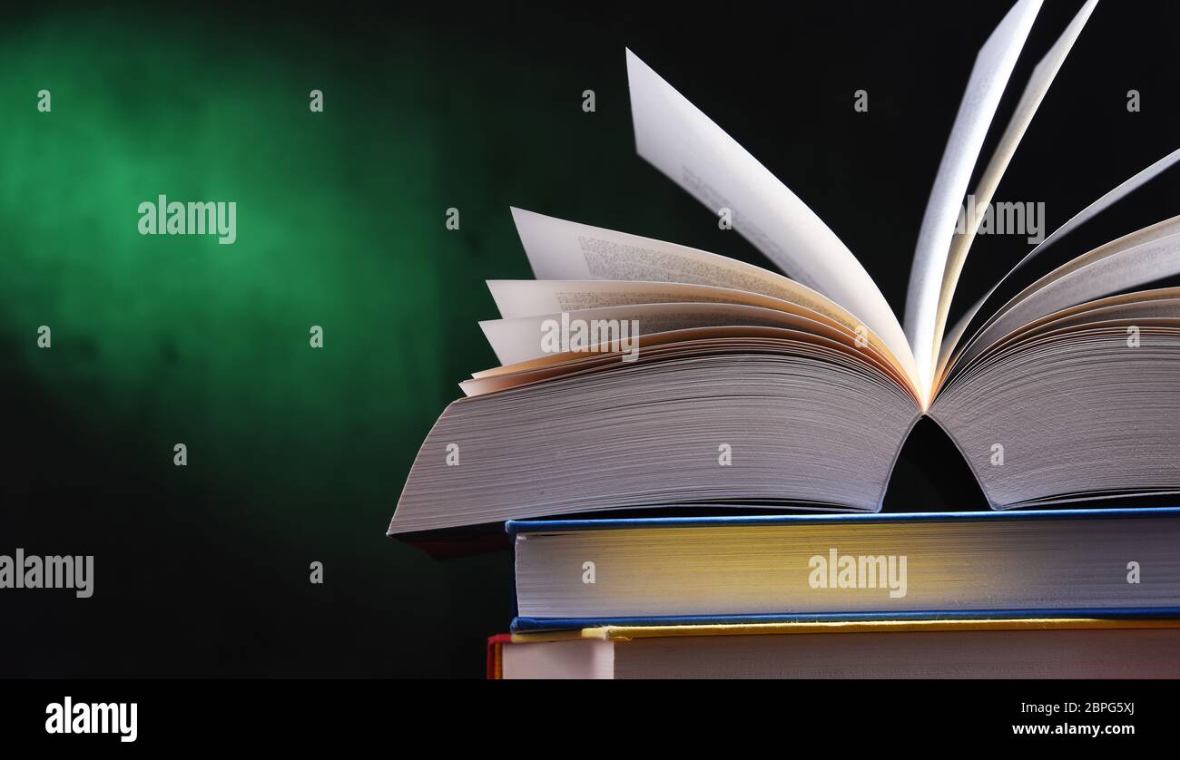Composition with open book on the table Stock Photo - Alamy