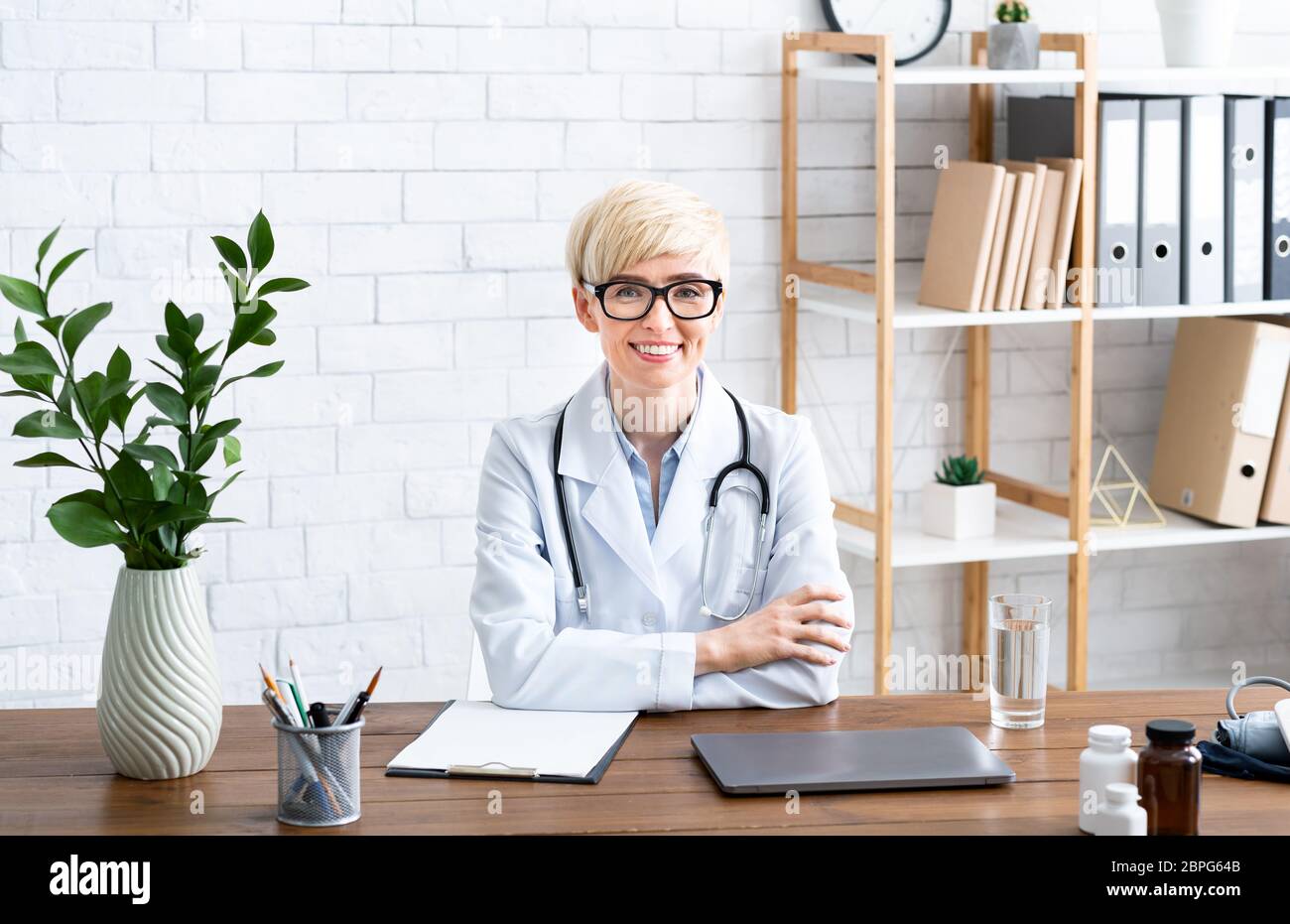 Practicing doctor concept. Woman in white coat and glasses Stock Photo ...