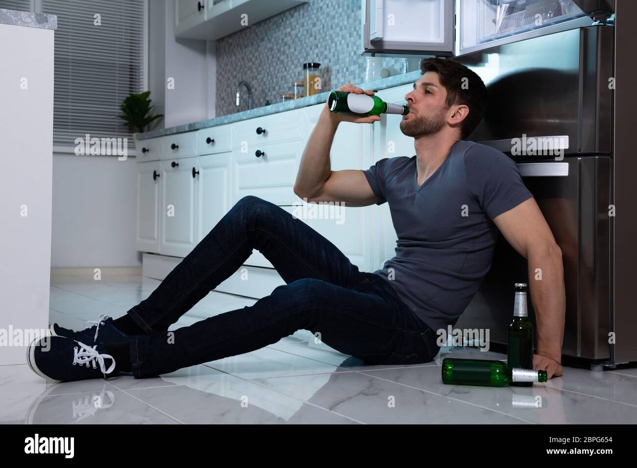Side View Of Young Man Drinking Beer In Front Of Refrigerator Stock ...