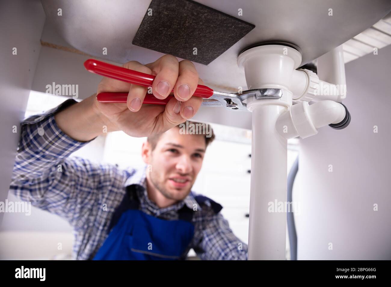 Plumber holding plastic pipe spanner hi-res stock photography and ...