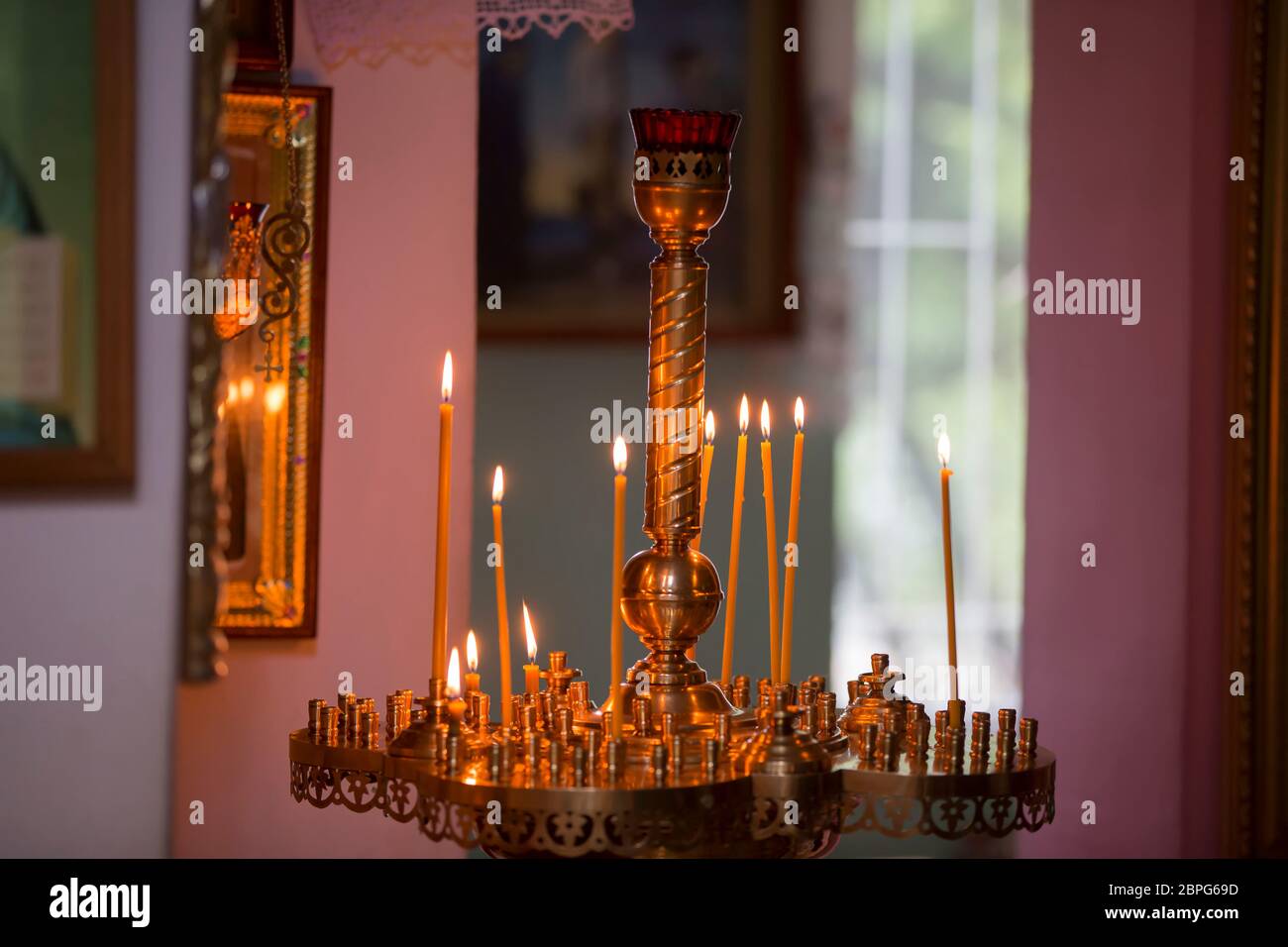 Church candles in a gold candlestick in the temple Stock Photo - Alamy