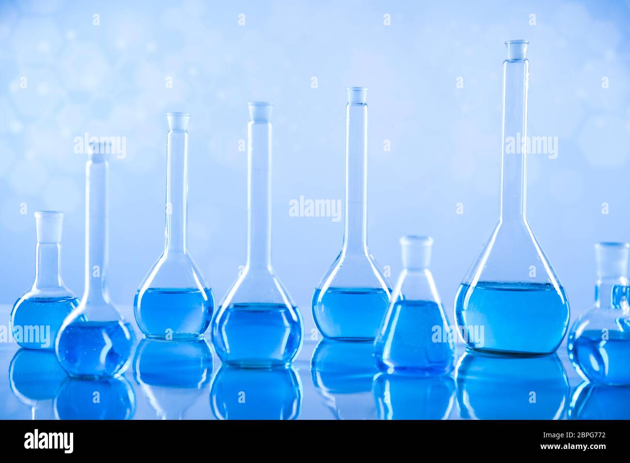 Laboratory beakers,Science experiment, blue background Stock Photo - Alamy