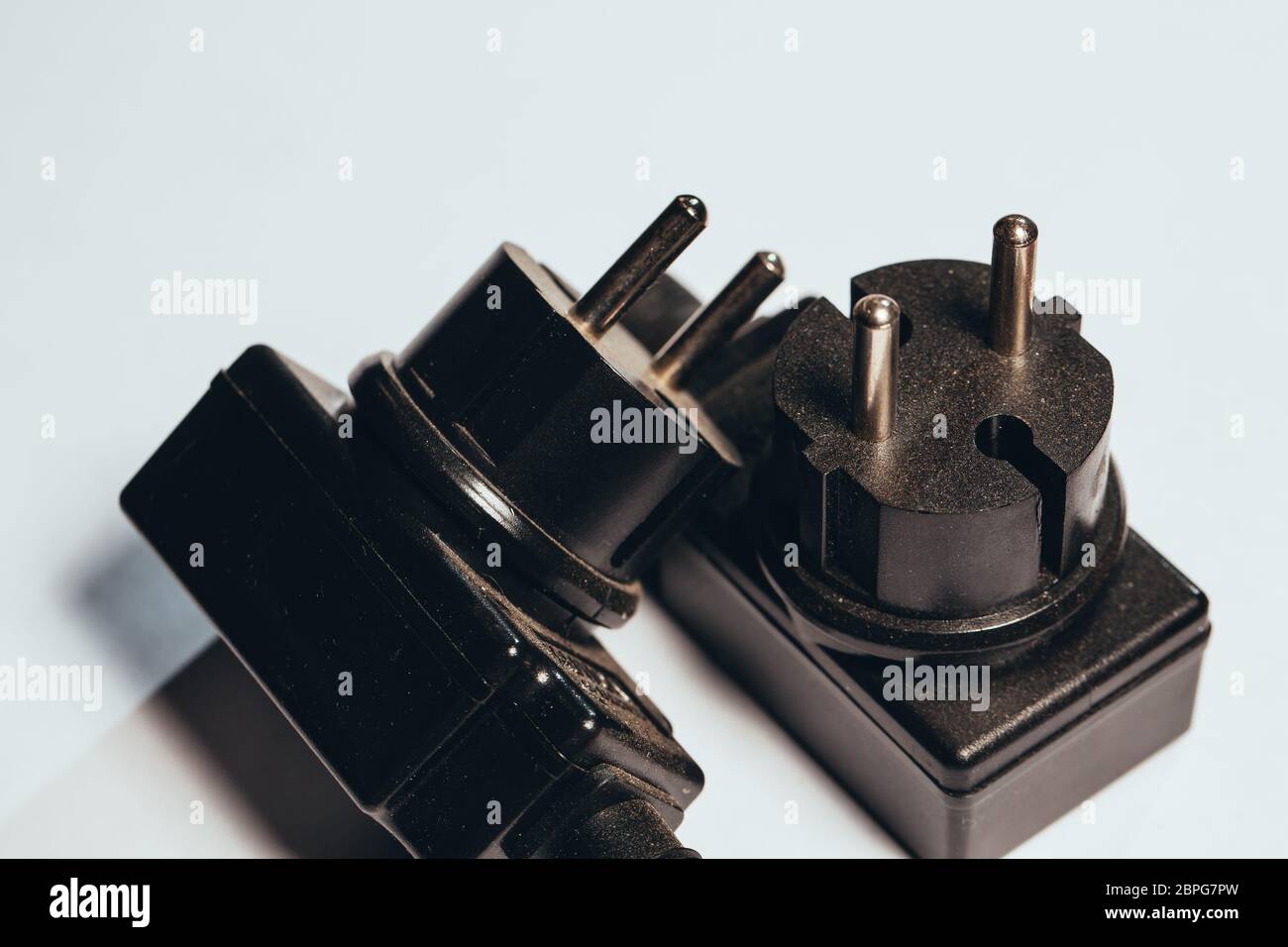 Black plug adapter on a light background Stock Photo - Alamy