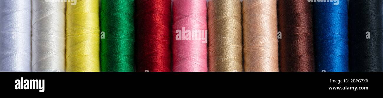 Colorful sewing threads in a row for a banner. The texture of multi ...