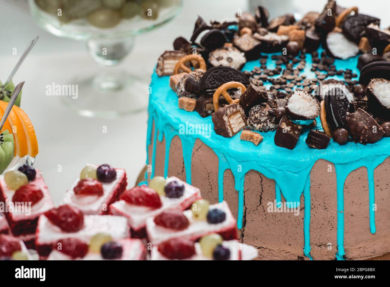 Children's blue birthday cake with candys on the top Stock Photo - Alamy