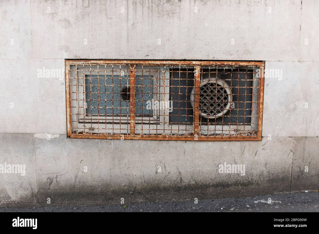 a close up view of small window air vents that has a metal mess ...