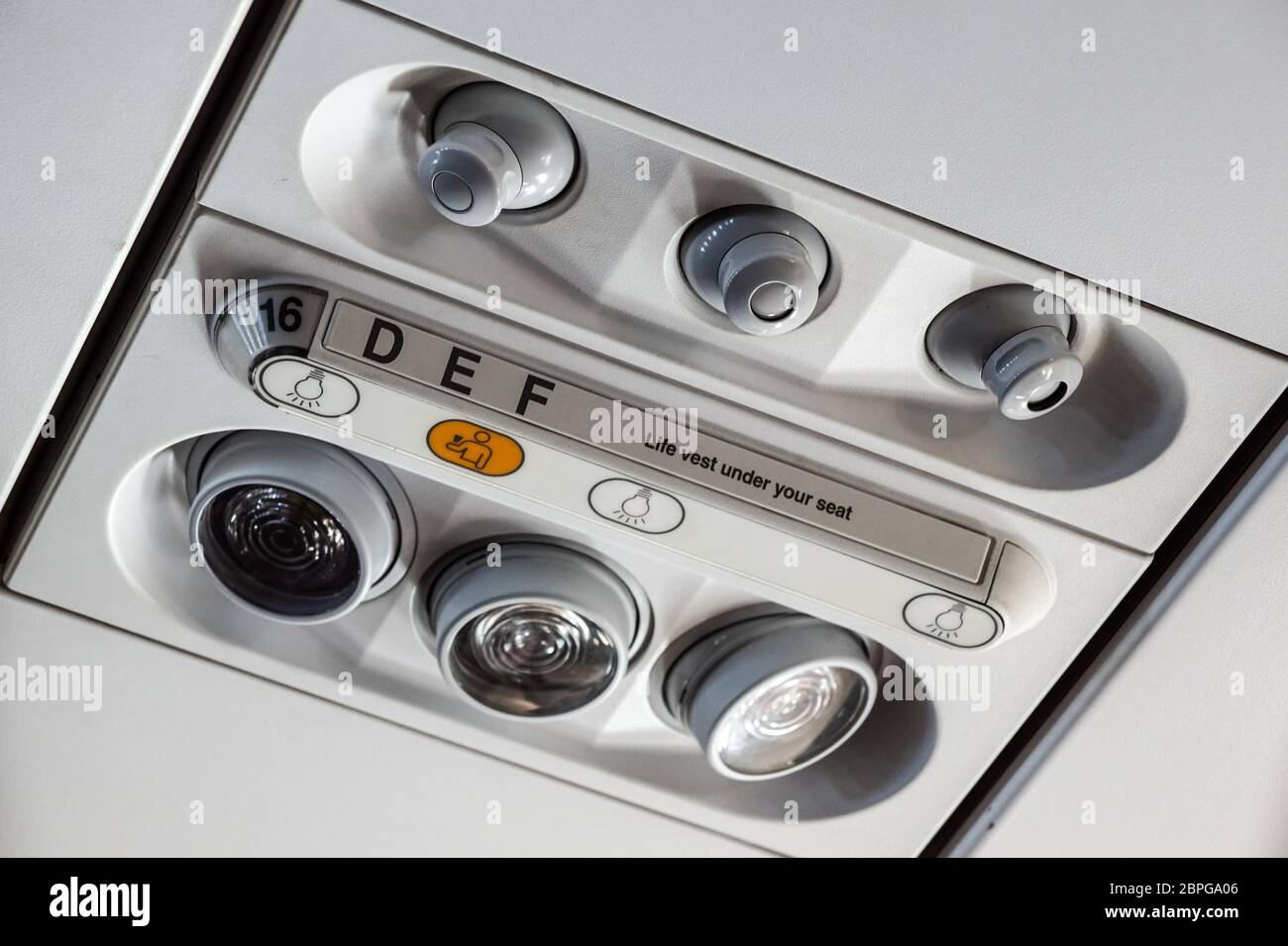 Cabin inside the aircraft, lights, air condition and signs panel above ...