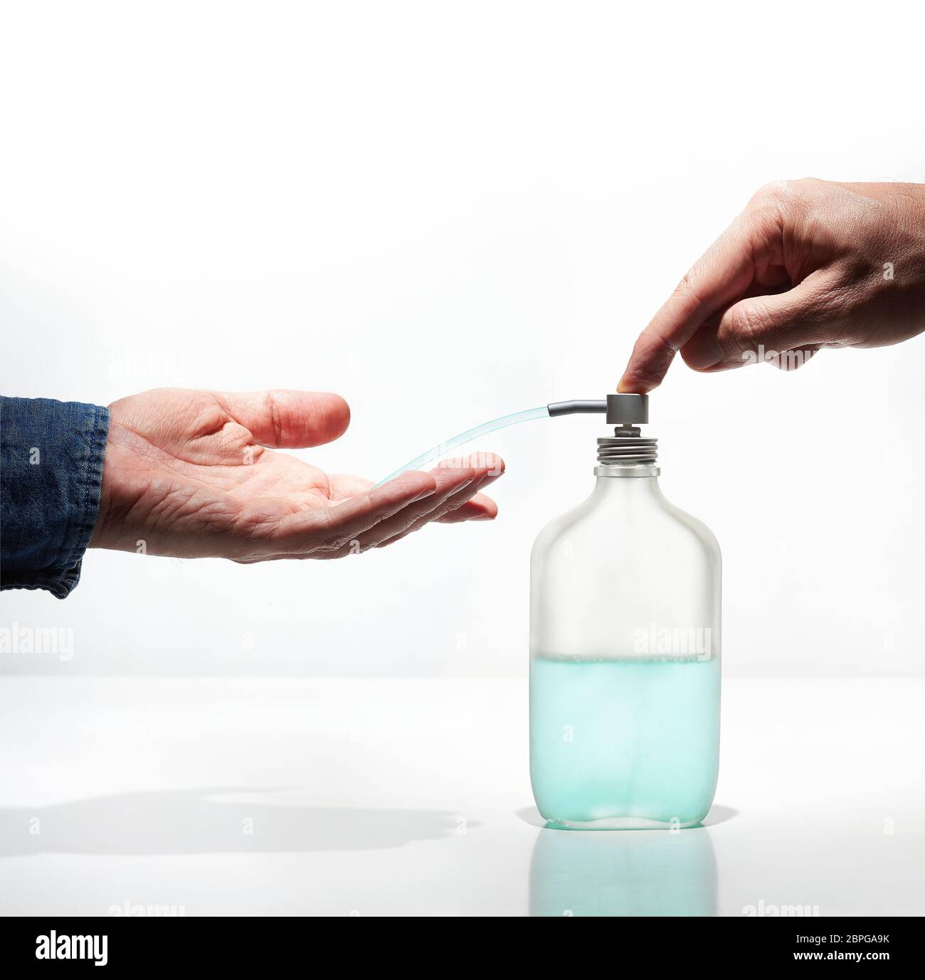 Using a sanitizer hi-res stock photography and images - Alamy