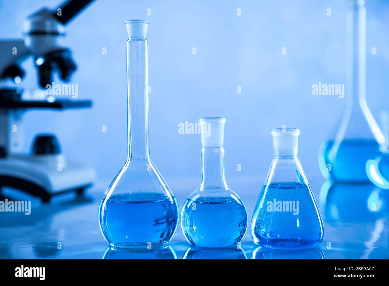 Laboratory beakers,Science experiment, blue background Stock Photo - Alamy