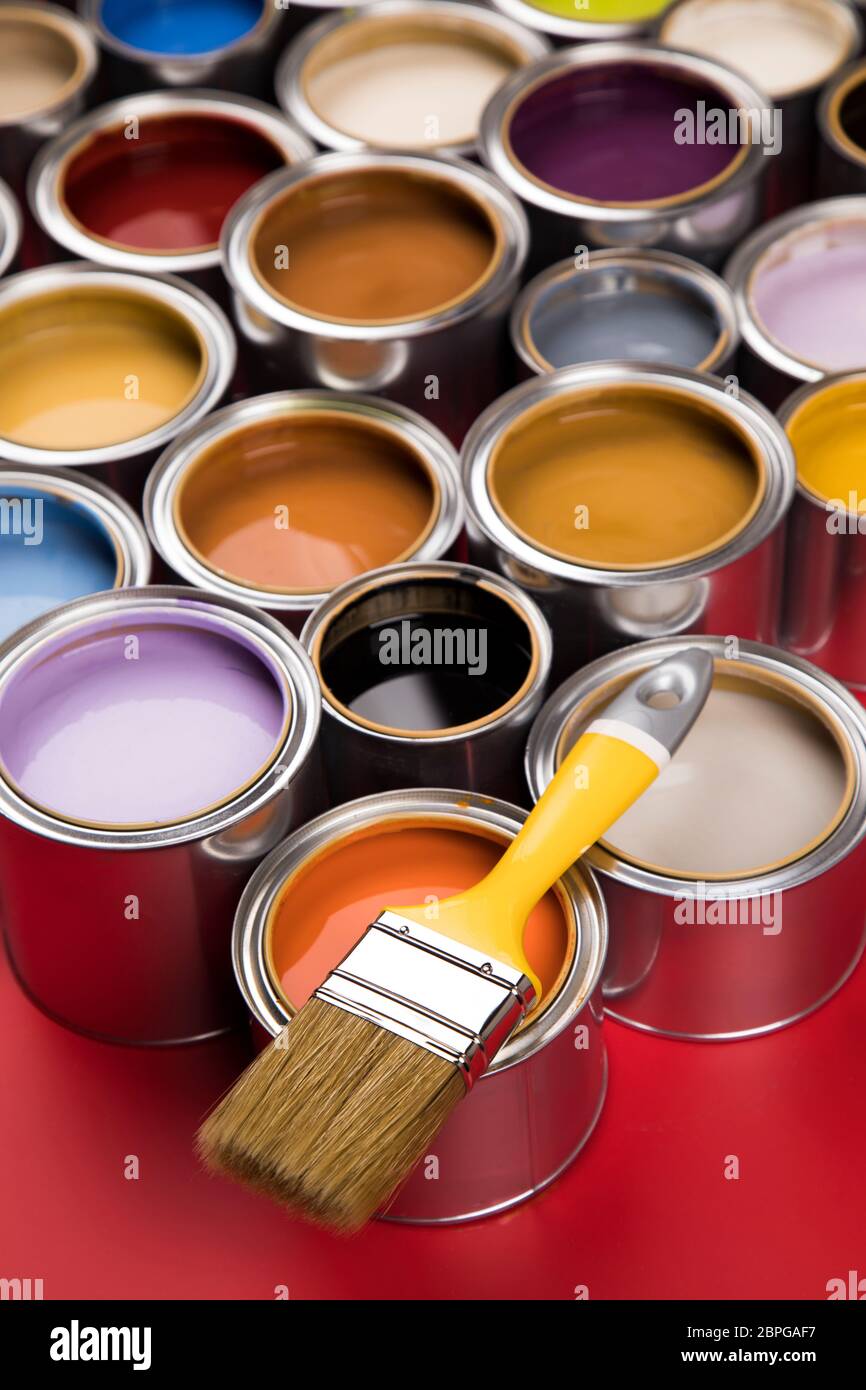Collection of colored paints cans, Brush, red background Stock Photo ...