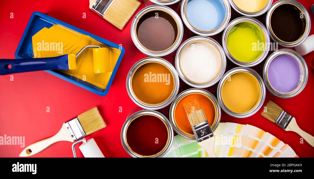 Open buckets with a paint and brush, red background Stock Photo - Alamy